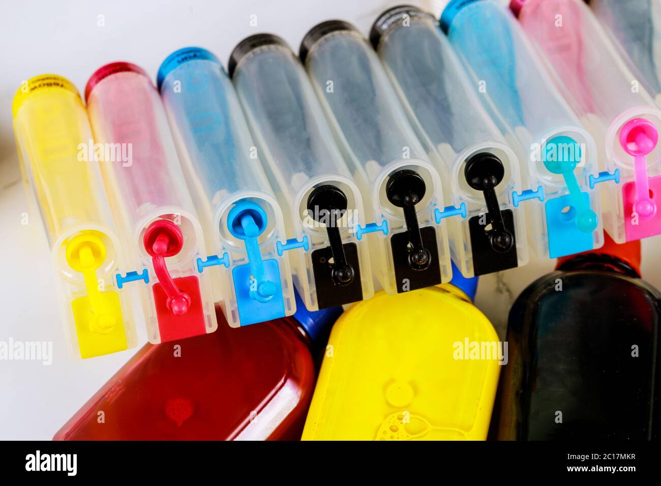 Ink tank connected to a jars of different colors stand in a row Stock ...