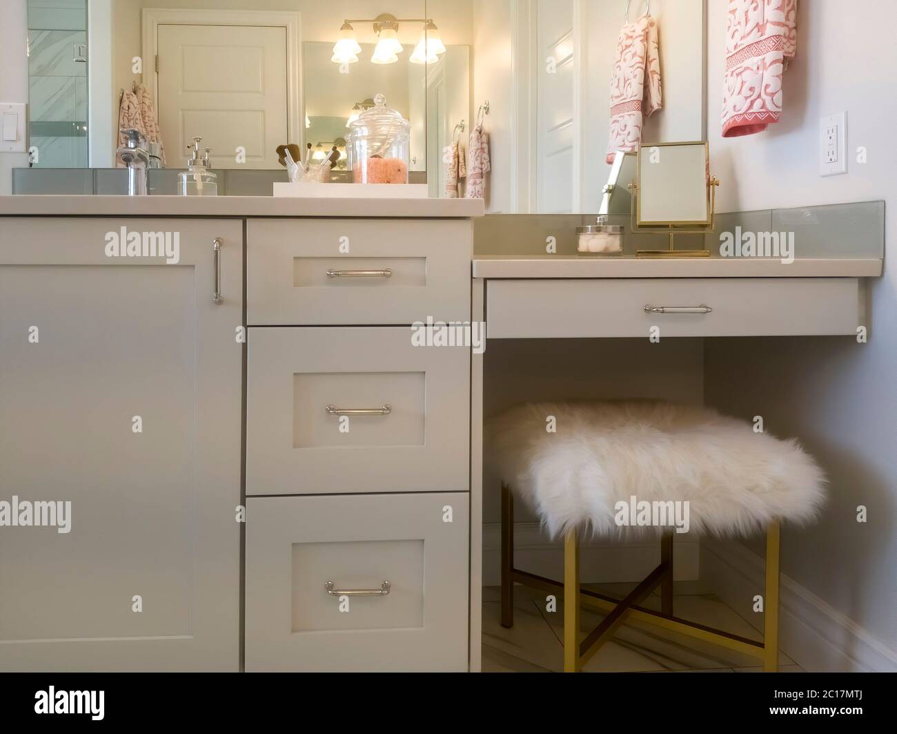 Vanity unit with cabinets sink mirror and faux fur stool inside ...