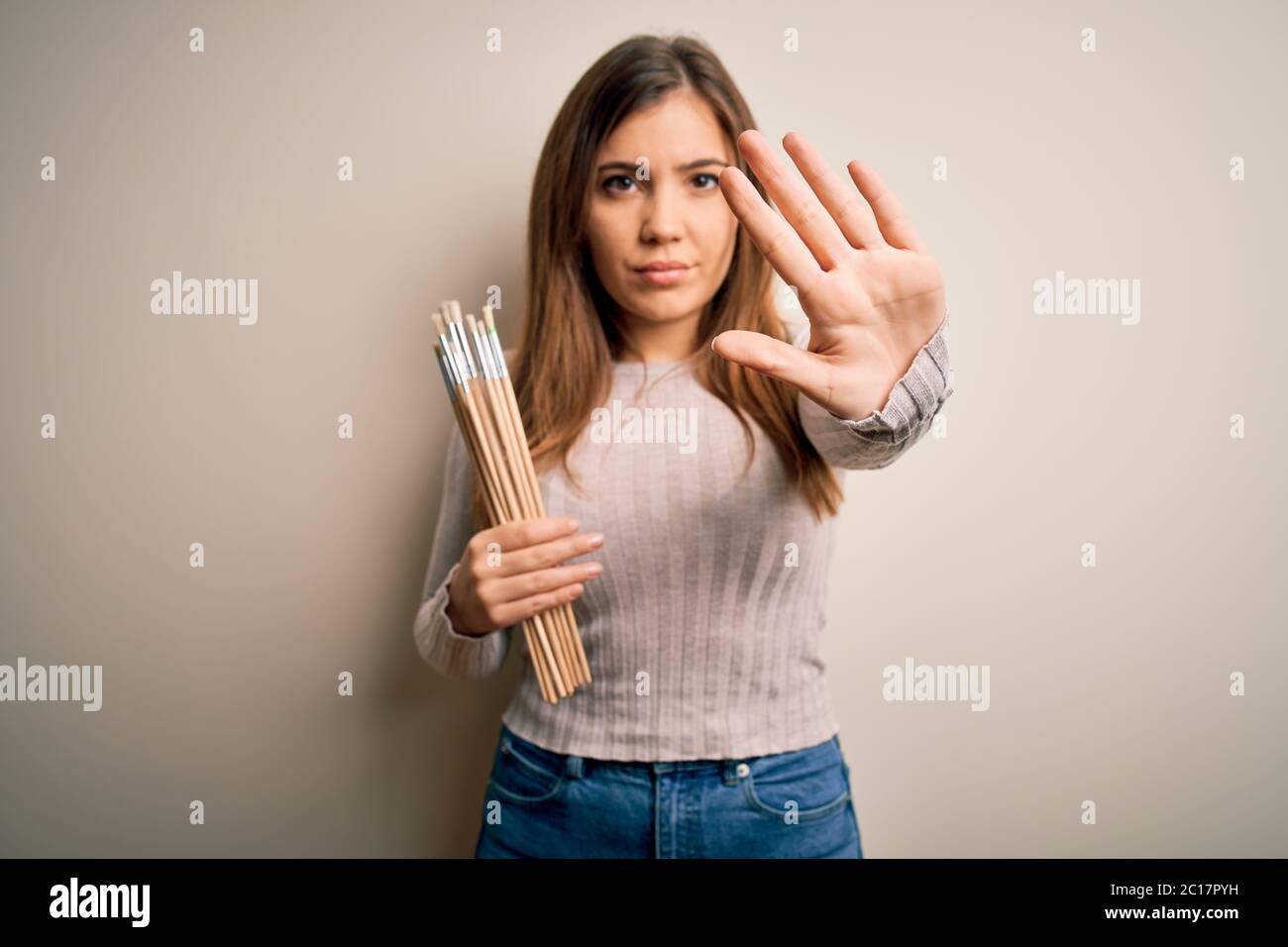 Young painter artist woman painting using paintbrush over isolated ...