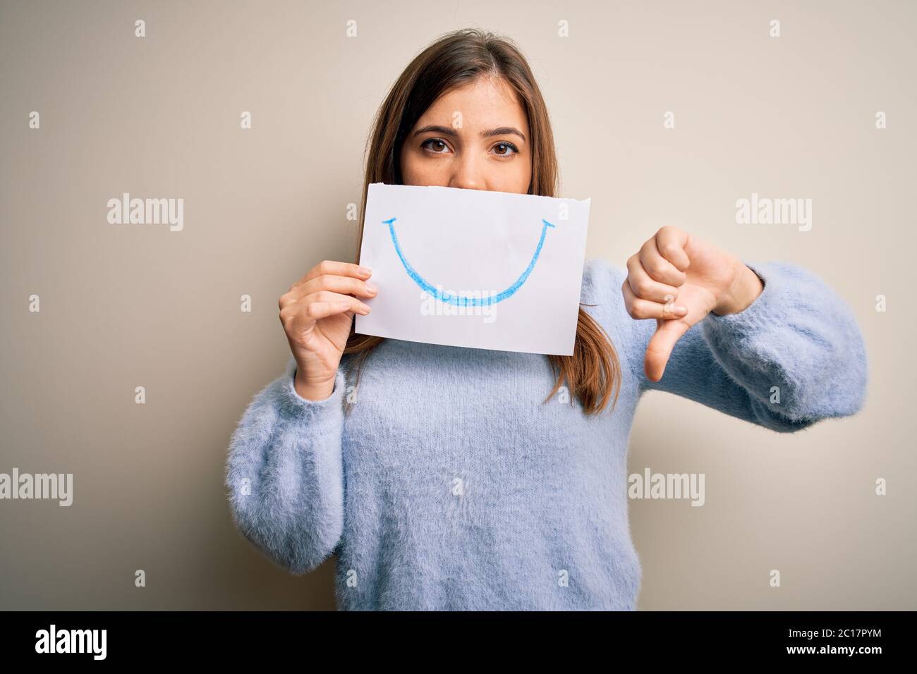 Young blonde woman holding funny smile drawing on mouth as happy ...