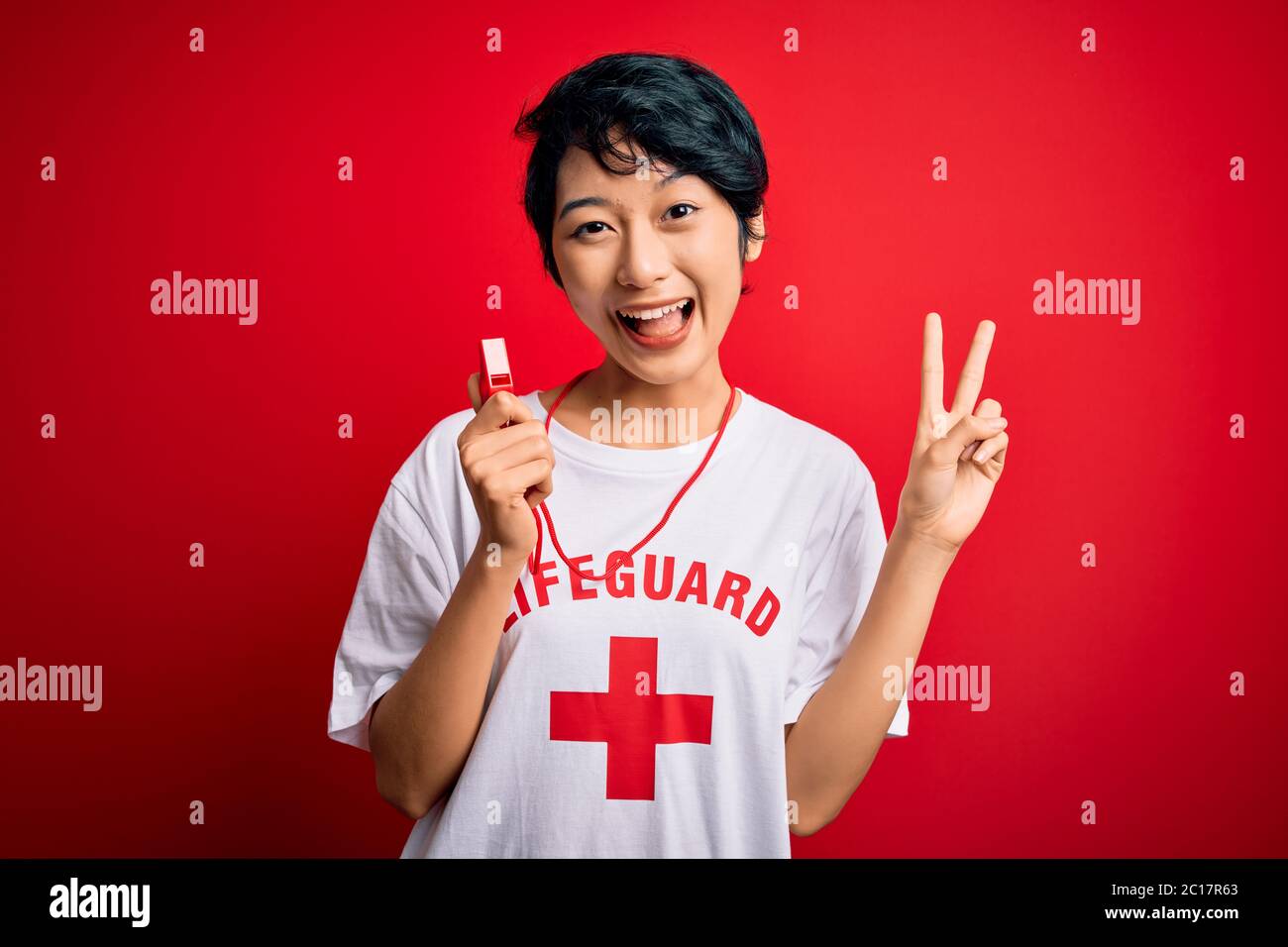 Young beautiful asian lifeguard girl wearing t-shirt with red cross ...