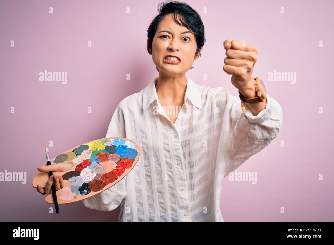 Young beautiful chinese artist woman painting using paintbrush and ...