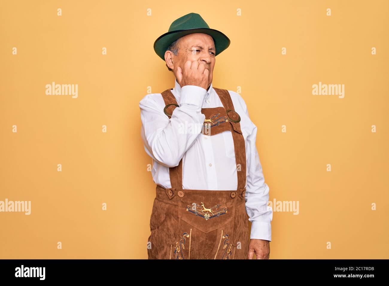 Senior grey-haired man wearing german traditional octoberfest suit over ...