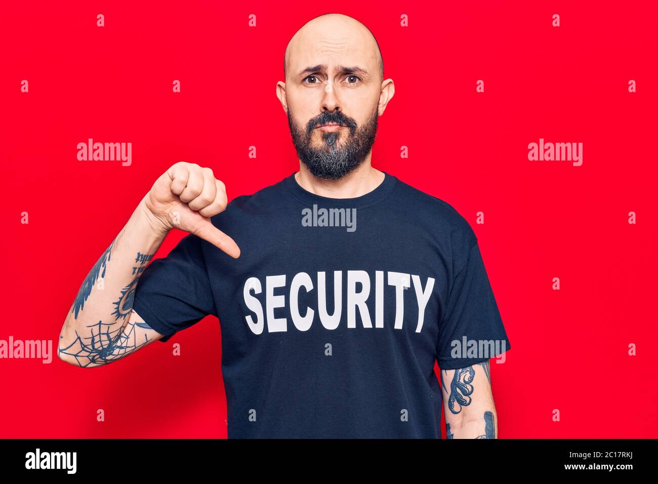 Young handsome man wearing security t shirt with angry face, negative ...