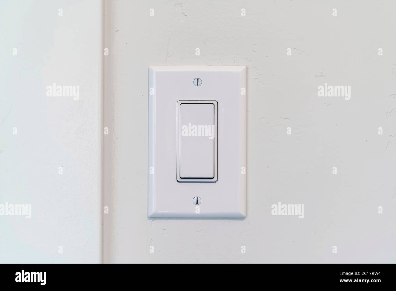 Electrical rocker light switch with flat broad lever on white interior ...