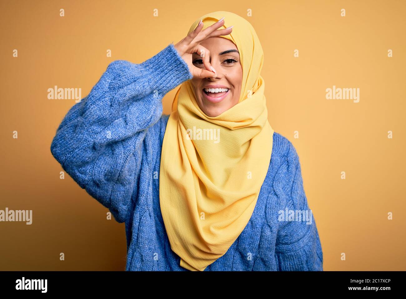 Young beautiful brunette muslim woman wearing arab hijab over isolated ...