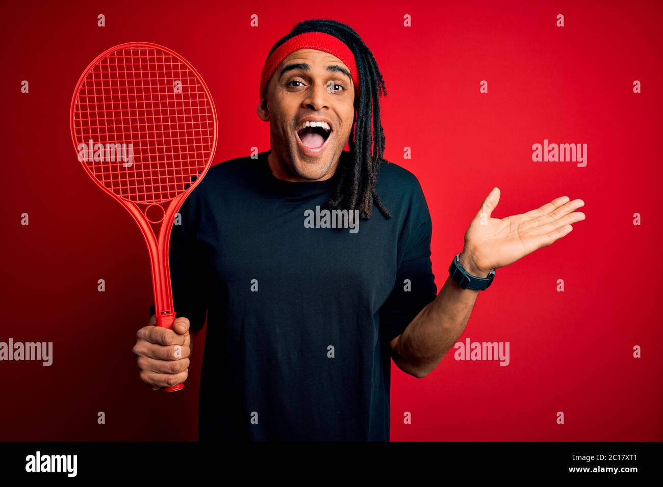 African american afro sportsman with dreadlocks holding tennis racket ...