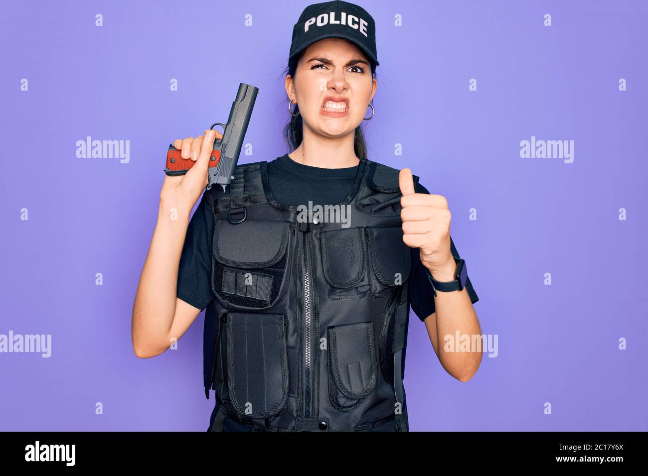 Young police woman wearing security bulletproof vest uniform and ...