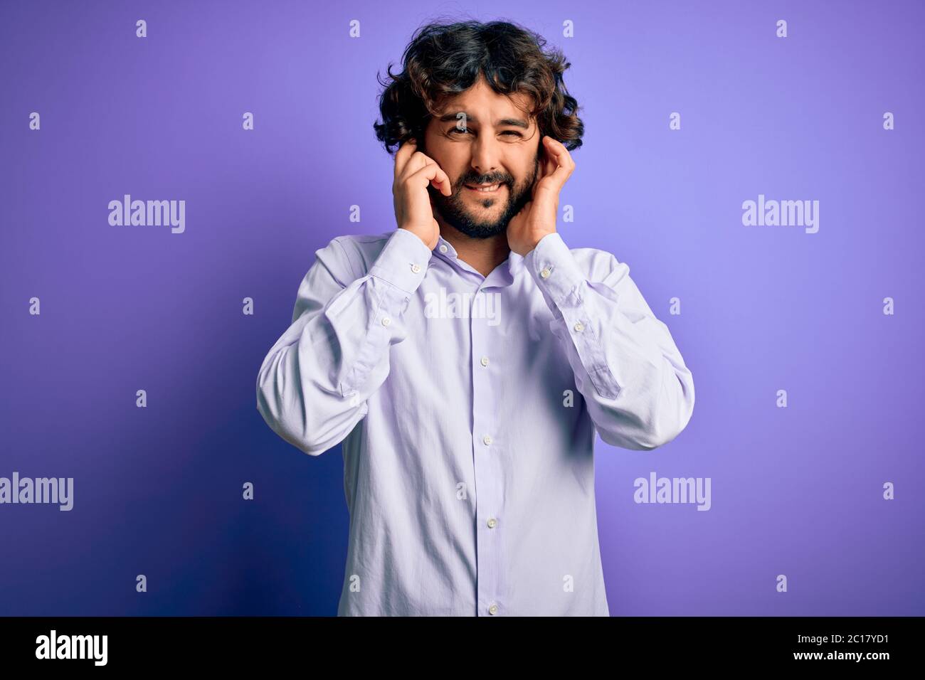Young handsome business man with beard wearing shirt standing over ...