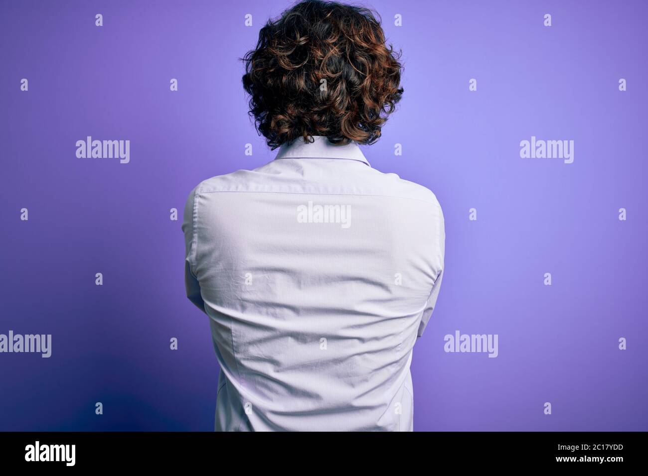Young handsome business man with beard wearing shirt standing over ...