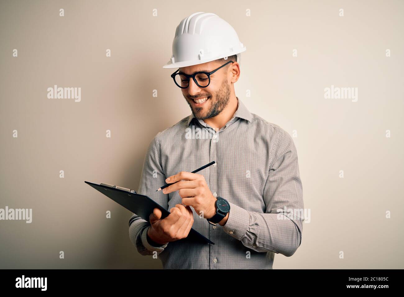 Young architect inspector man wearing builder safety helmet and using ...