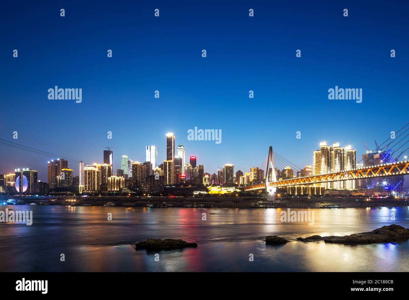 cityscape of modern city near water at twilight Stock Photo - Alamy