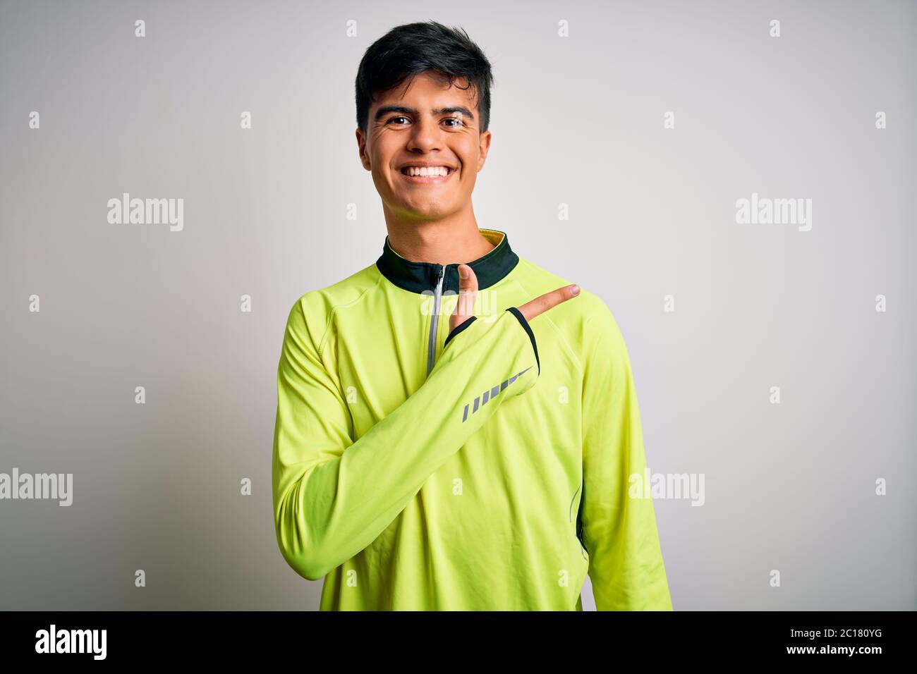 Young handsome sportsman doing sport wearing sportswear over isolated ...