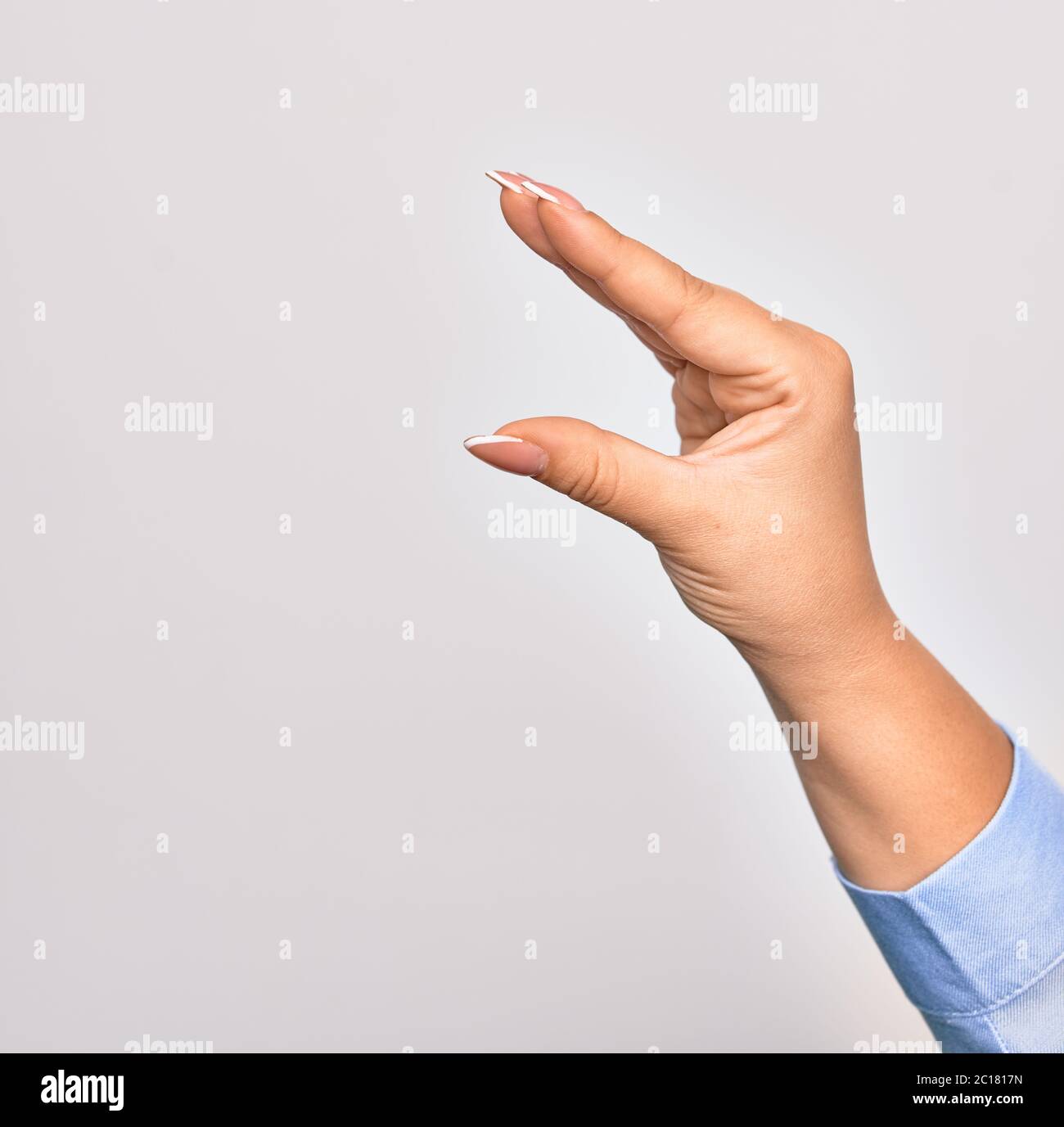 Hand of caucasian young woman doing catch sign over isolated white ...