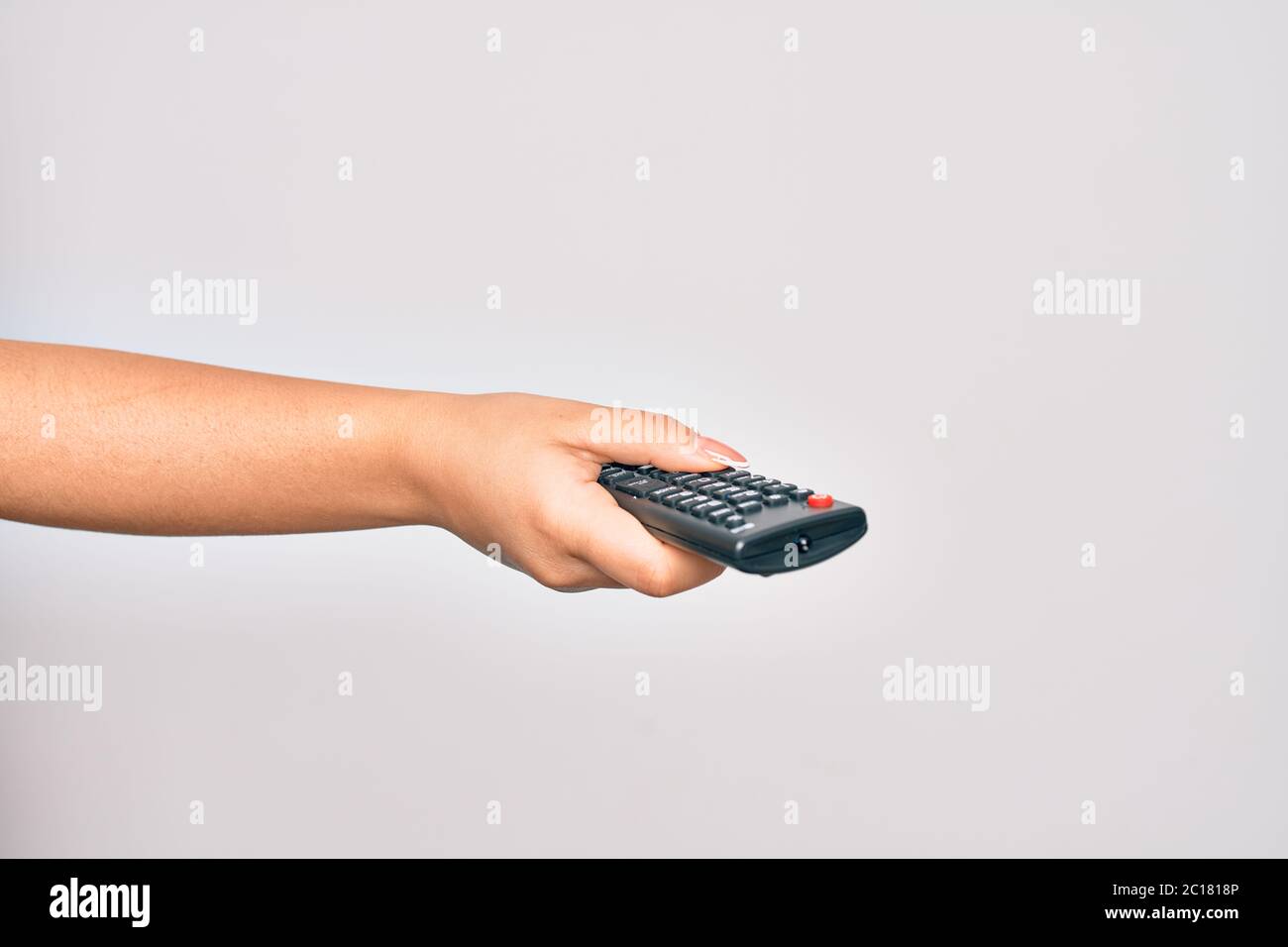 Hand of caucasian young woman changing television channel holding tv ...