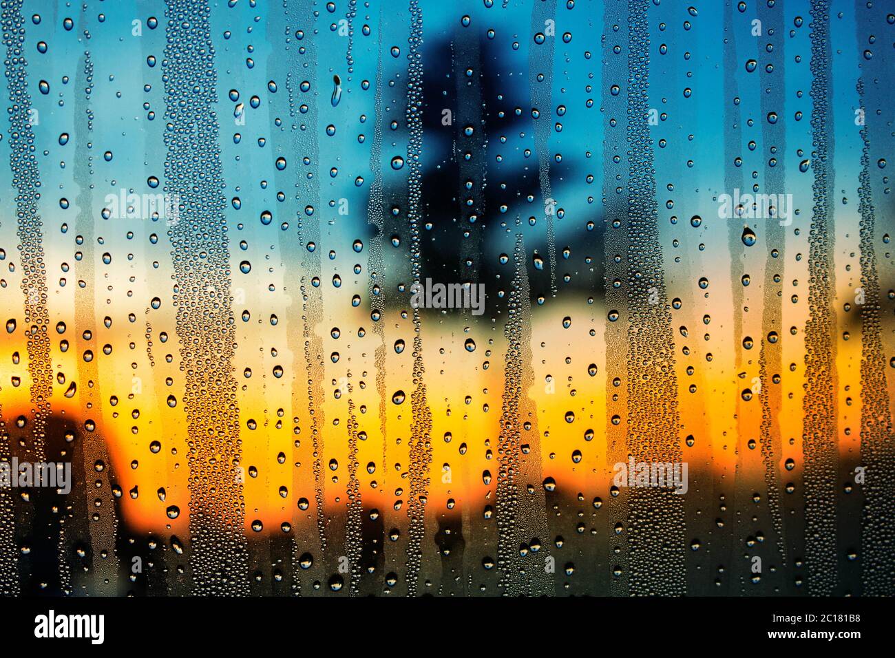 Water droplets on glass at sunrise Stock Photo - Alamy