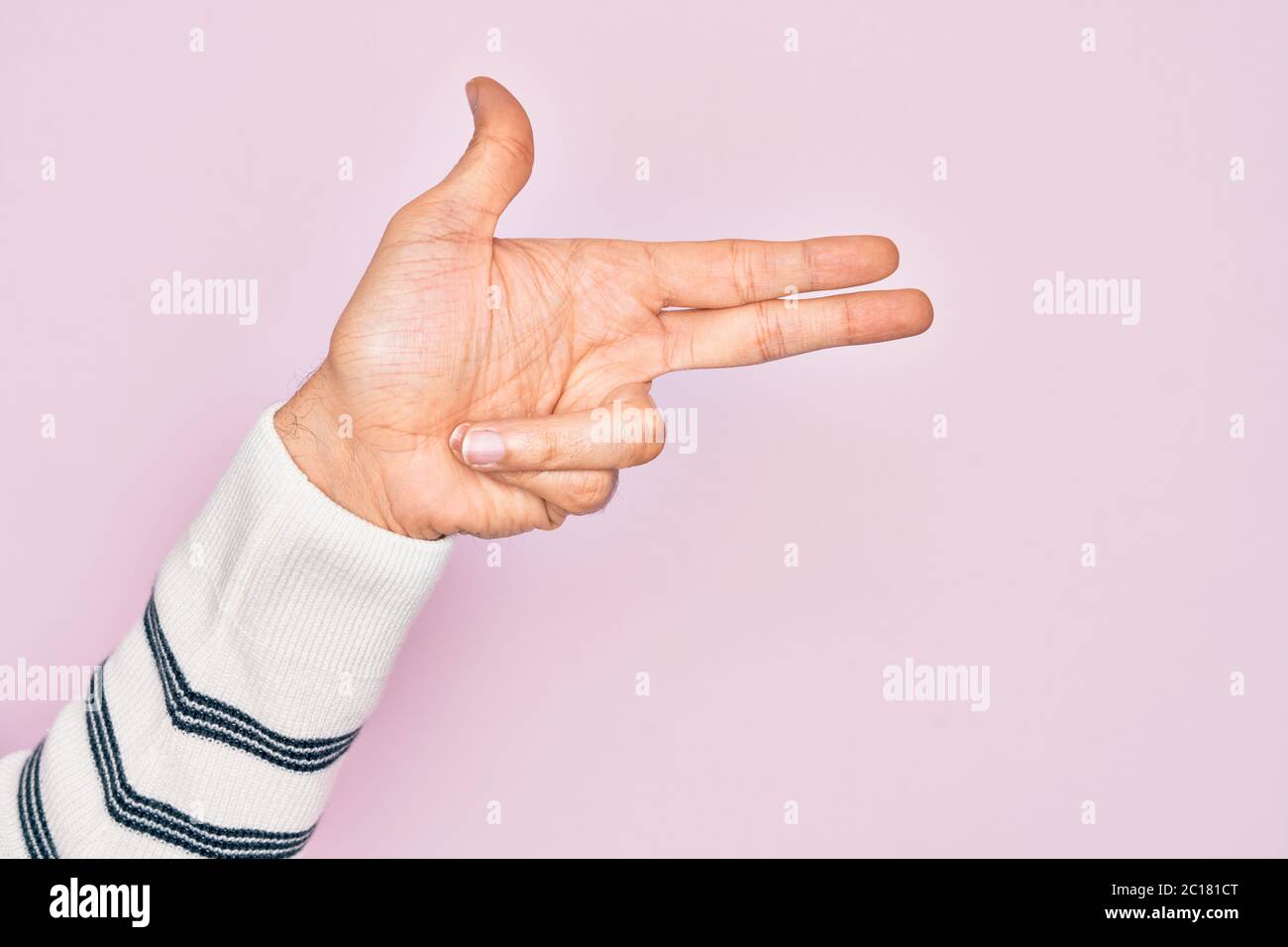 Hand of caucasian young man showing fingers over isolated pink ...