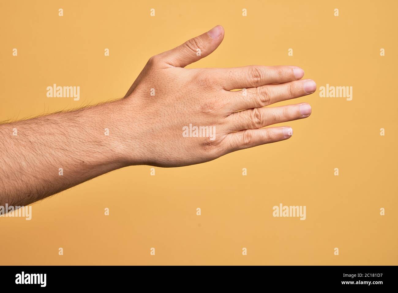 Hand of caucasian young man showing fingers over isolated yellow ...
