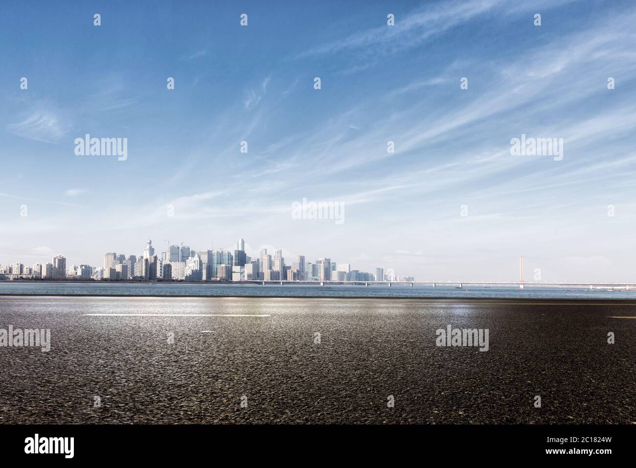 empty road with cityscape of modern city near water Stock Photo - Alamy