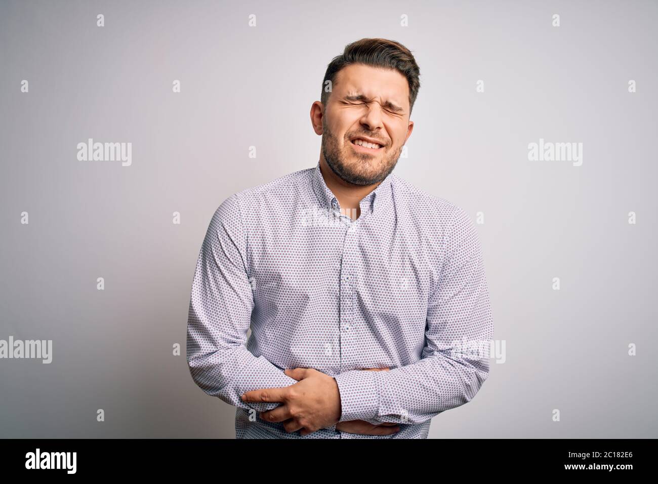 Young business man with blue eyes standing over isolated background ...