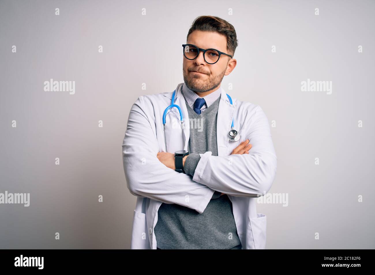 Young doctor man with blue eyes wearing medical coat and stethoscope ...
