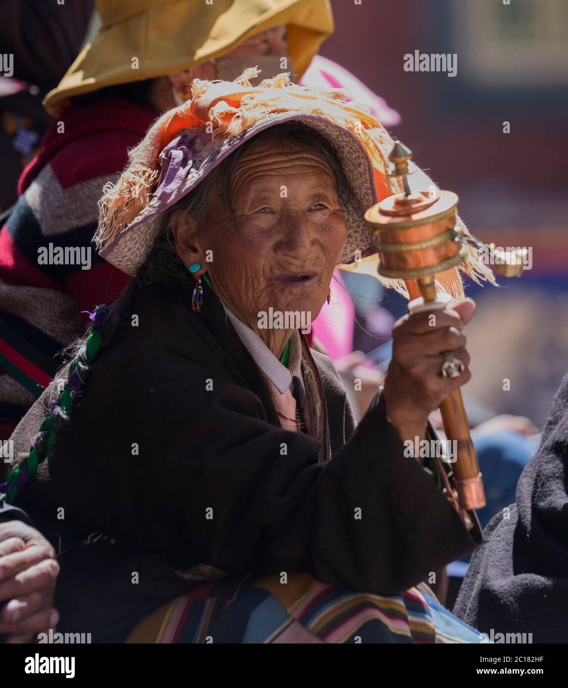 Pilgrims view the sacred cham dance during the festival at Tsurphu ...