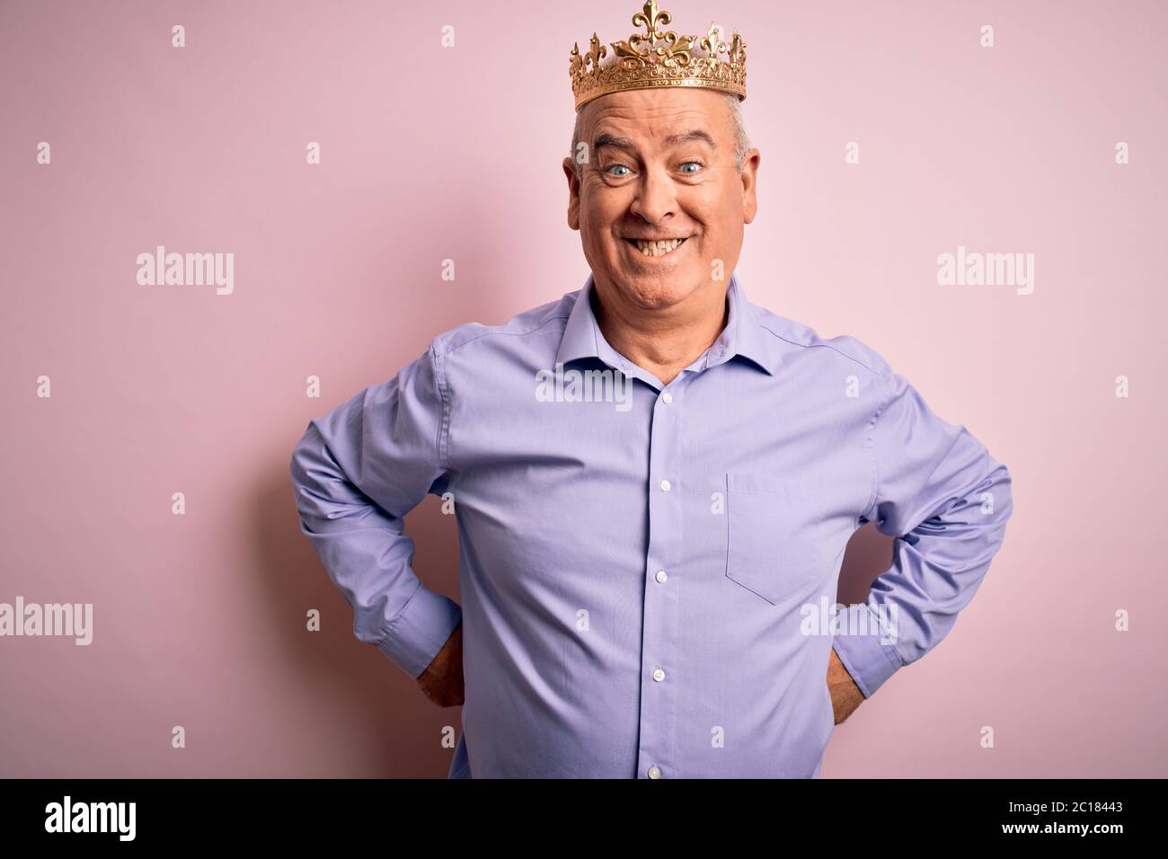 Middle age hoary man wearing golden crown of king standing over ...
