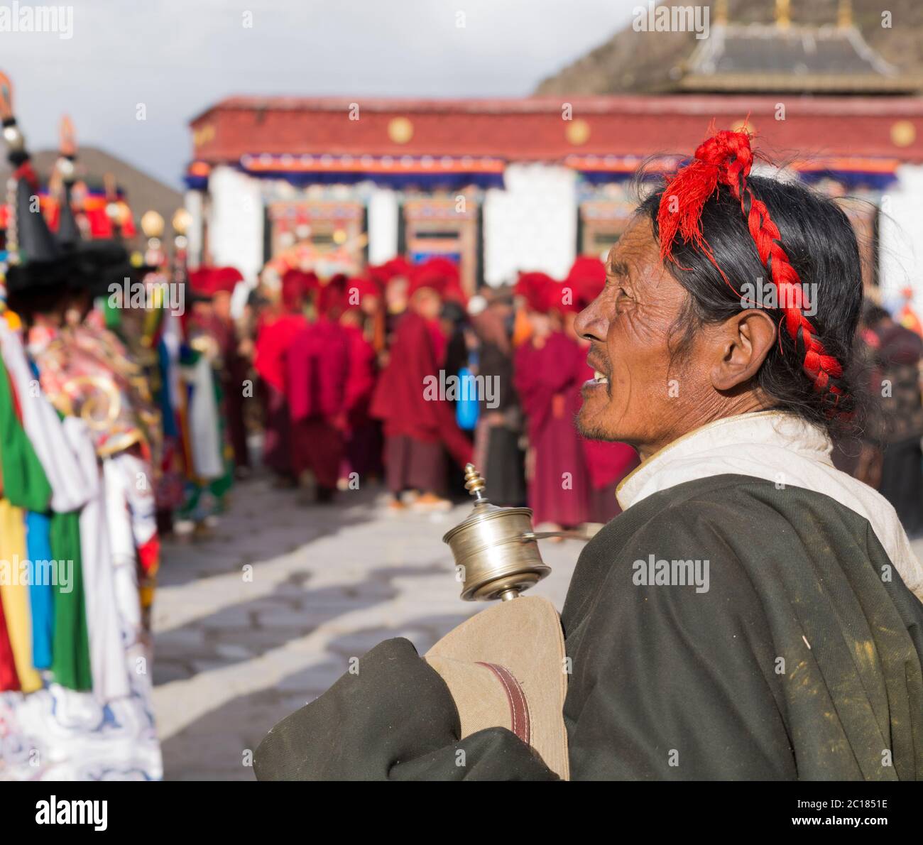 Pilgrims view the sacred cham dance during the festival at Tsurphu ...