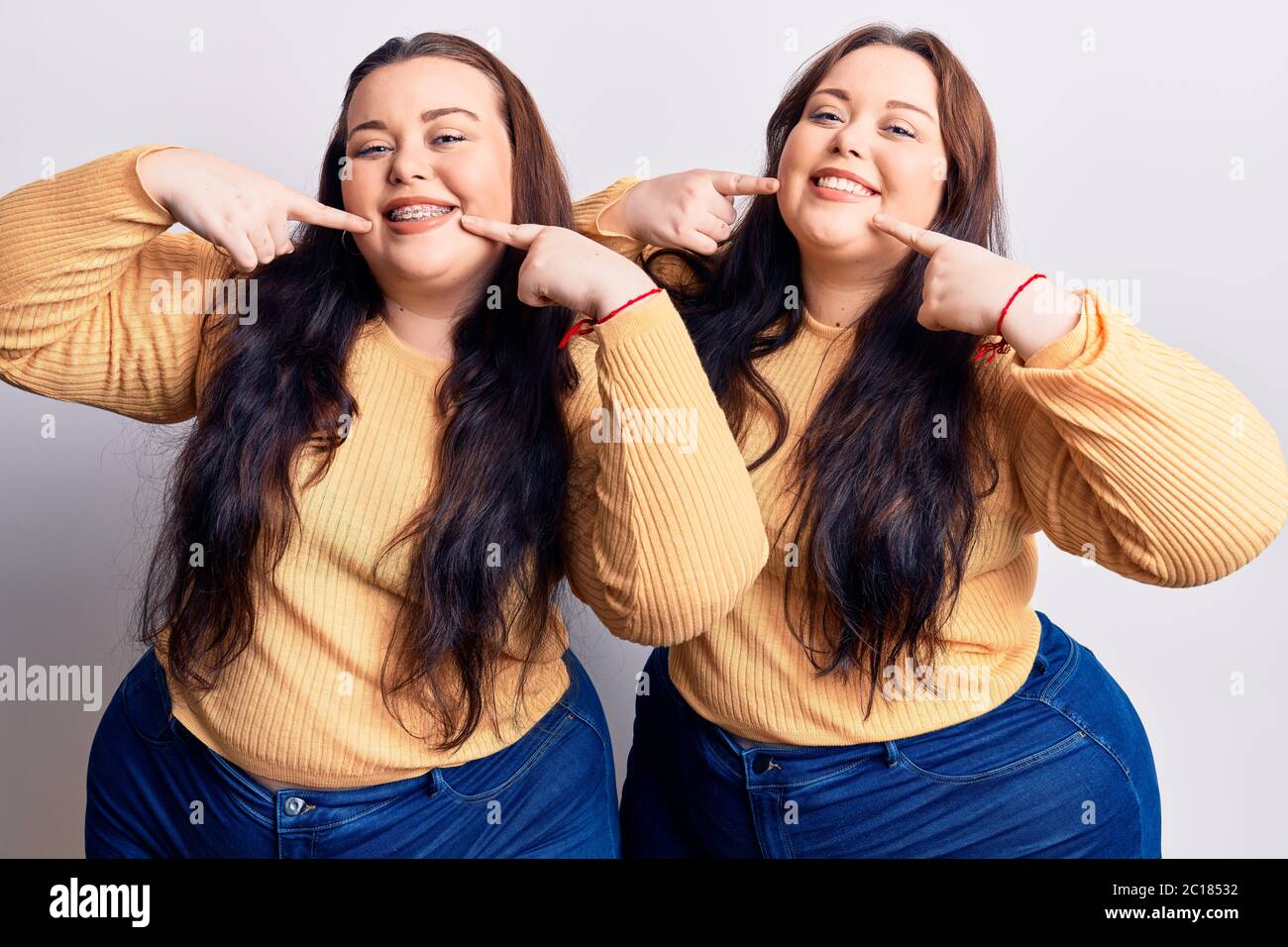 Young plus size twins wearing casual clothes smiling cheerful showing ...