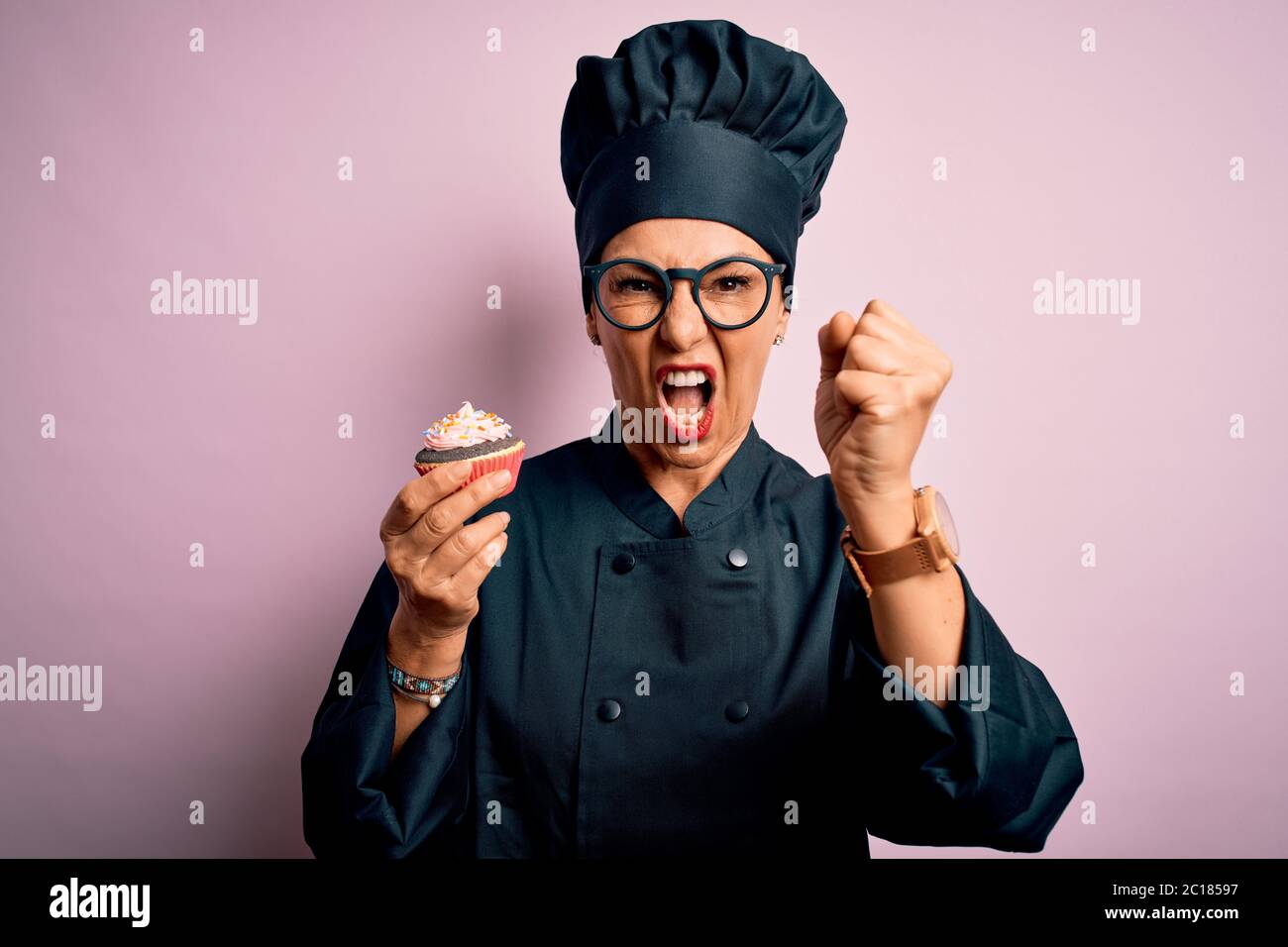 Middle age baker woman wearing cooker uniform and hat holding delicious ...