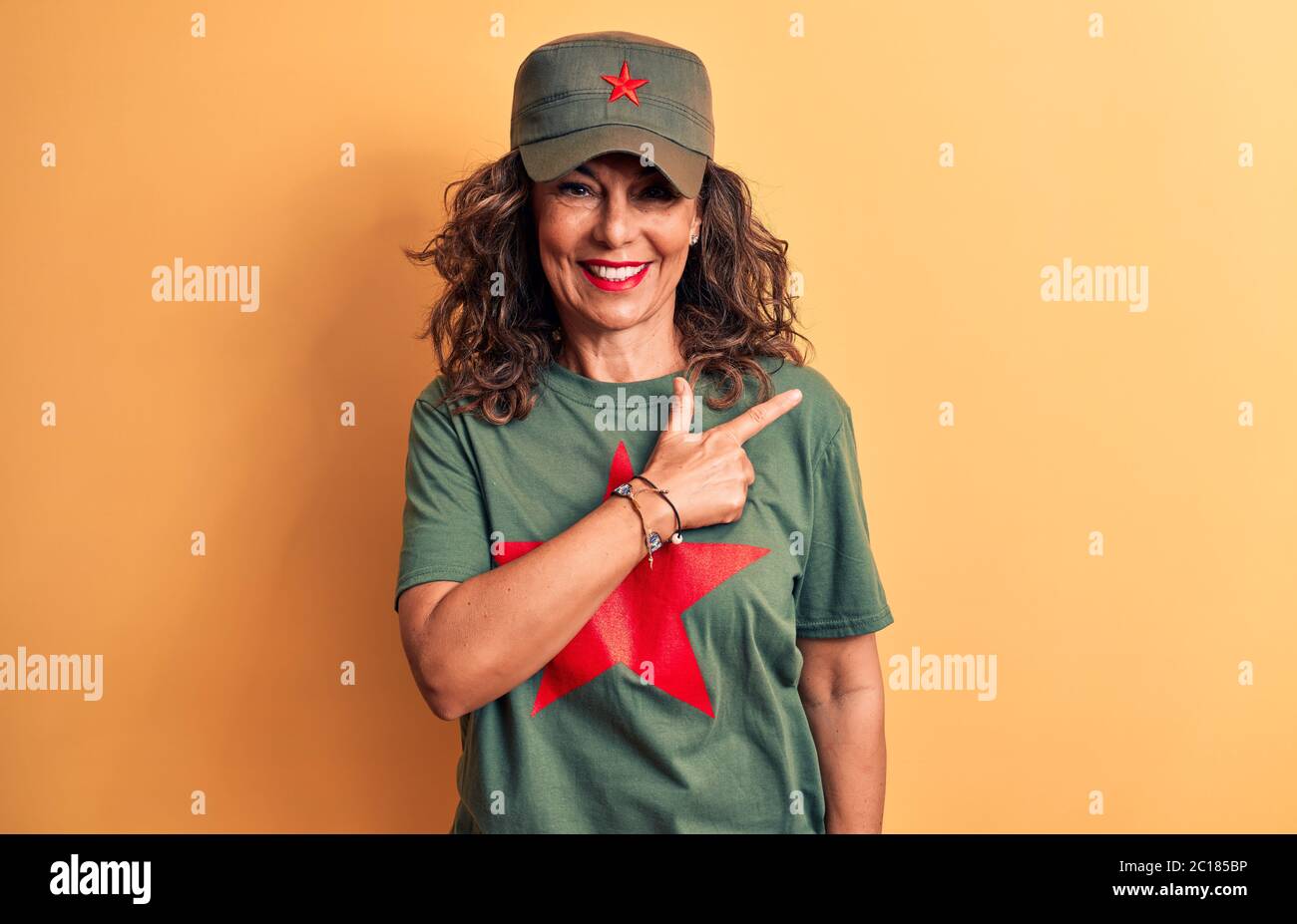 Middle age brunette woman wearing t-shirt and cap with red star symbol ...
