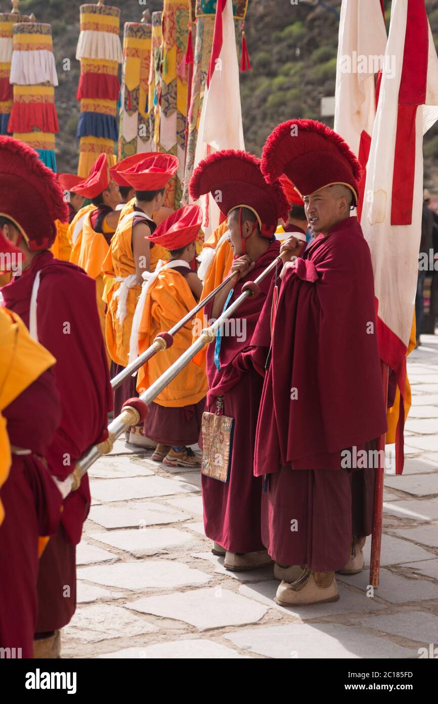 A procession of monks during the Tsurphu monastery festival, Tibet ...