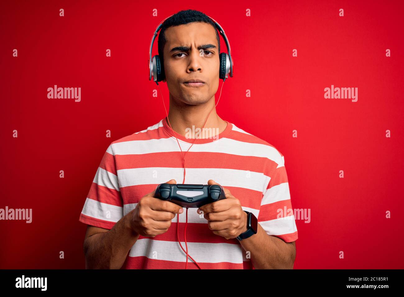 Handsome african american gamer man playing video game using jostick ...