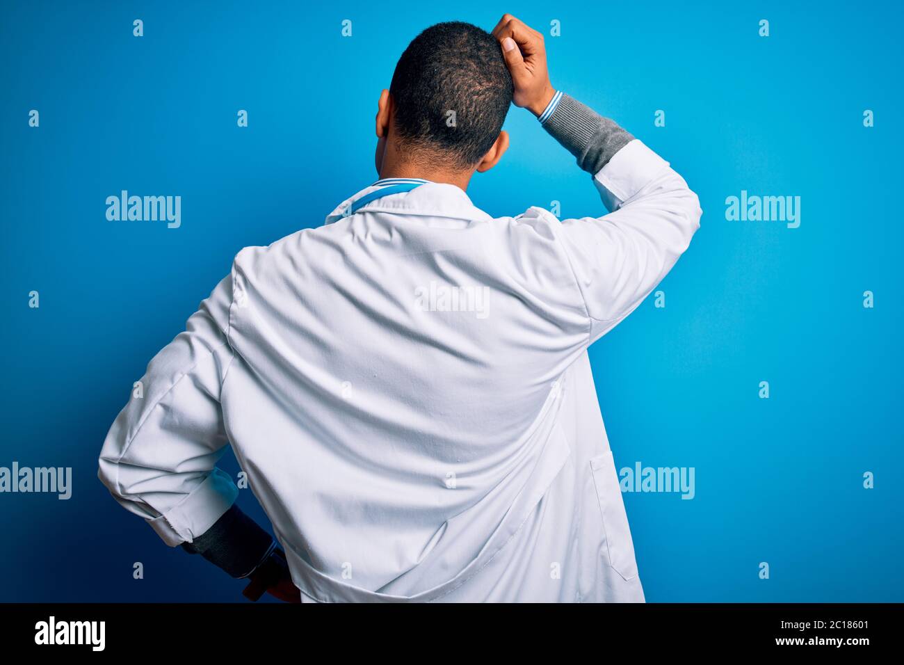 Handsome african american doctor man wearing coat and stethoscope over ...