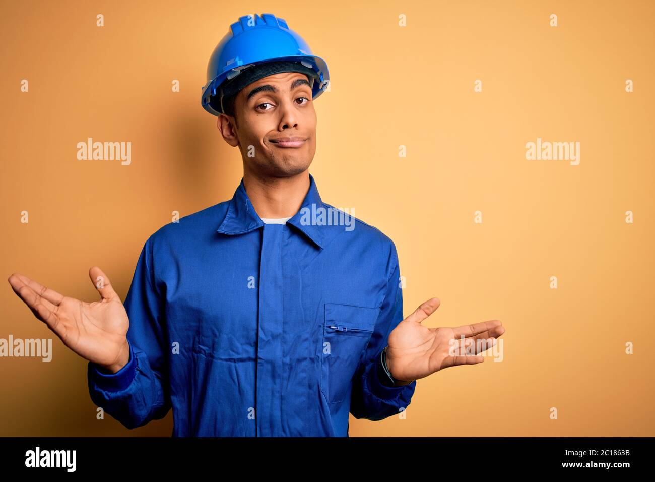 Young handsome african american worker man wearing blue uniform and ...