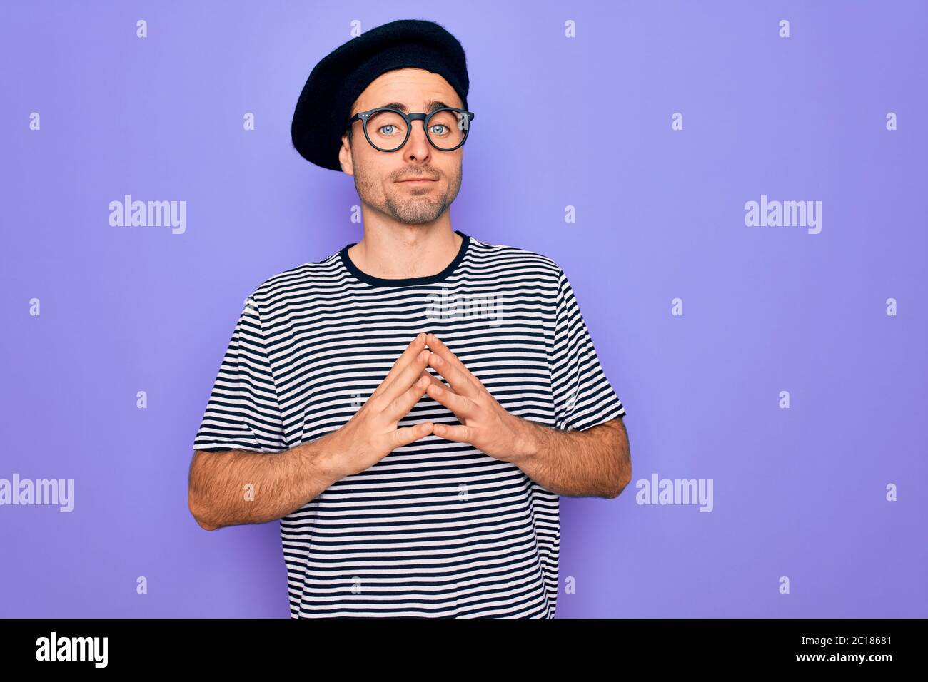 Handsome man with blue eyes wearing striped t-shirt and french beret ...