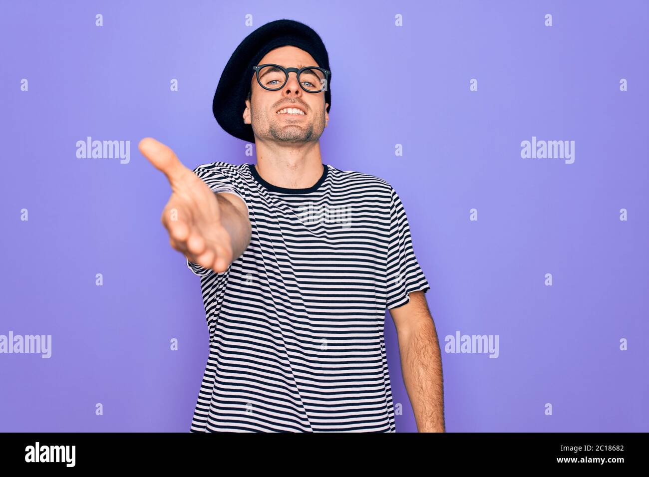 Handsome man with blue eyes wearing striped t-shirt and french beret ...
