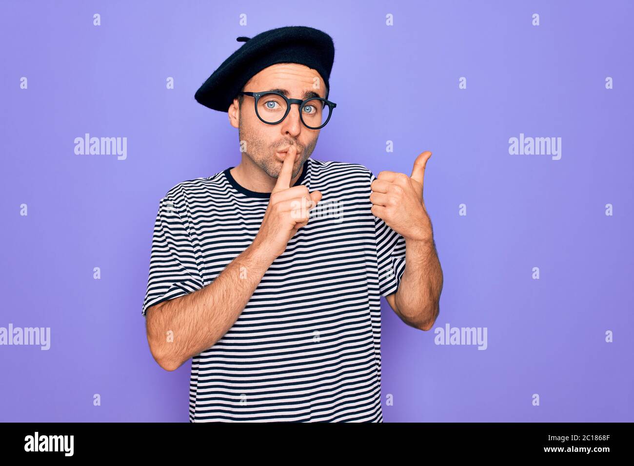 Handsome man with blue eyes wearing striped t-shirt and french beret ...