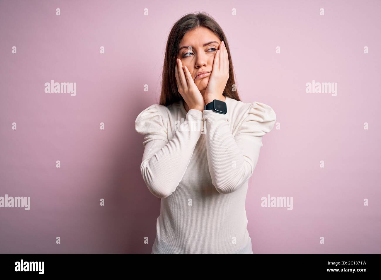 Young beautiful woman with blue eyes wearing casual white t-shirt over ...
