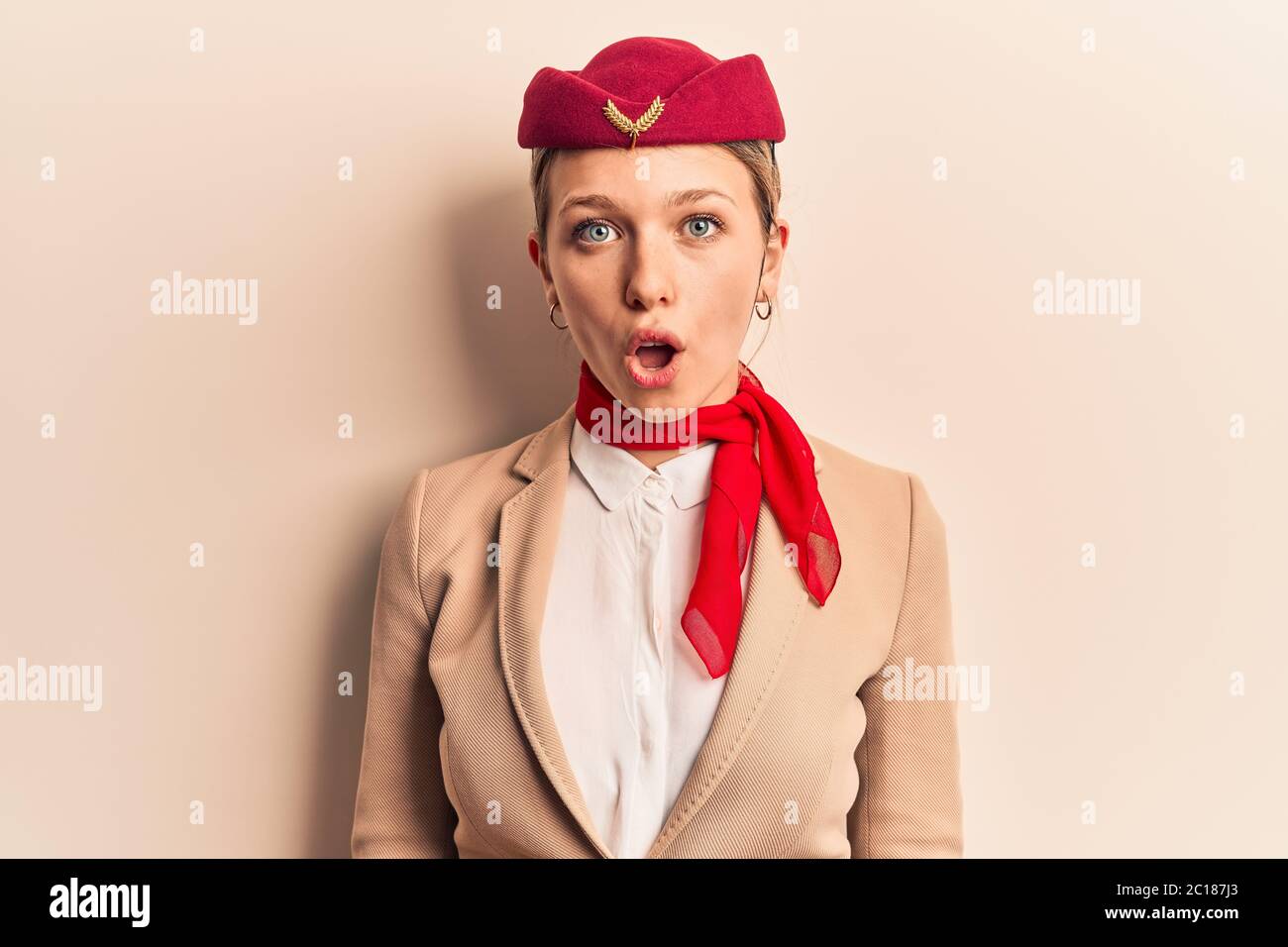 Young beautiful blonde girl wearing stewardess uniform scared and ...