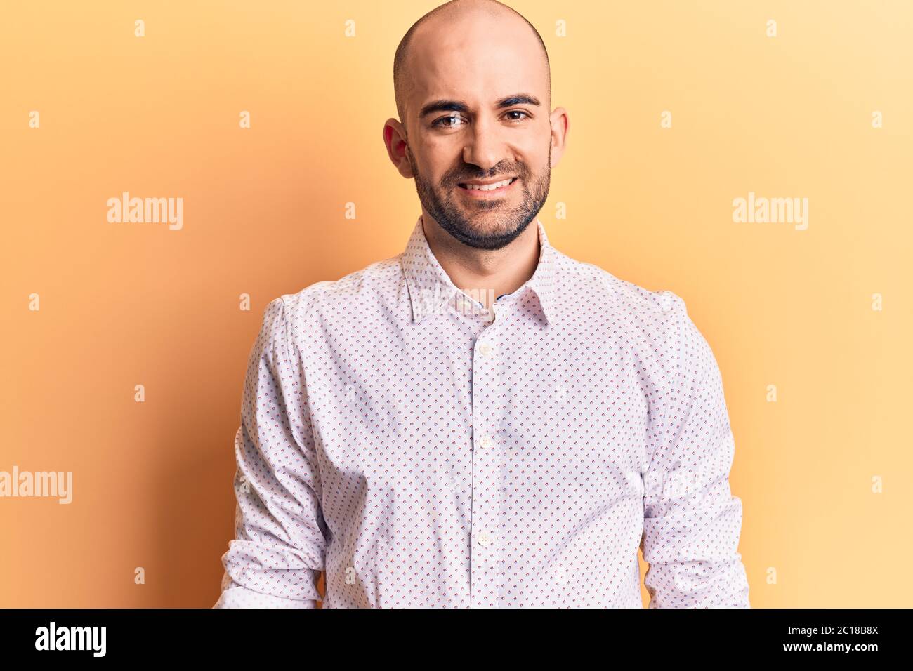 Young handsome bald man wearing elegant shirt with a happy and cool ...