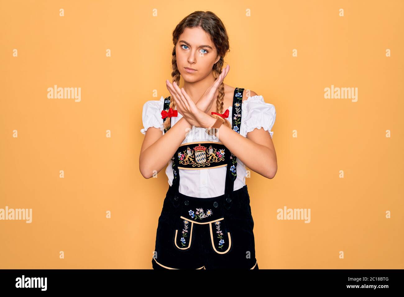 Young beautiful blonde german woman with blue eyes wearing traditional ...