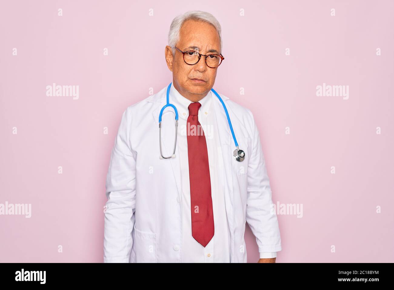 Middle age senior grey-haired doctor man wearing stethoscope and ...