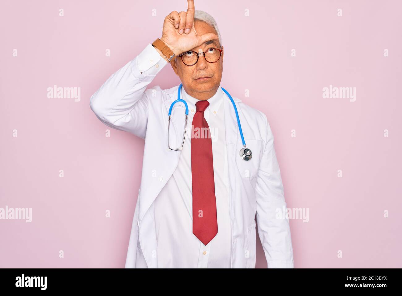 Middle age senior grey-haired doctor man wearing stethoscope and ...