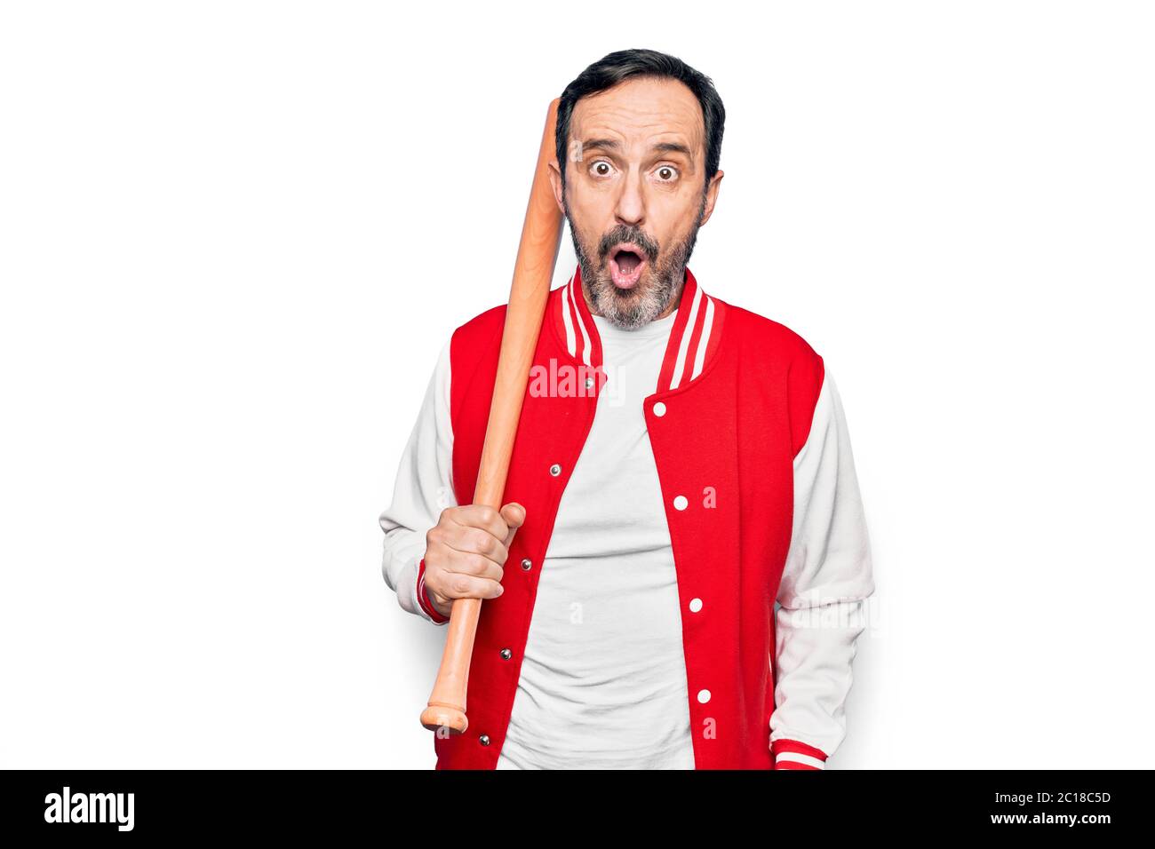 Middle age handsome sporty man wearing jacket playing baseball using ...