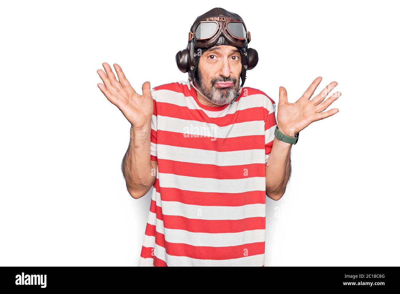 Middle age aviator man wearing vintage helmet and glasses over isolated ...