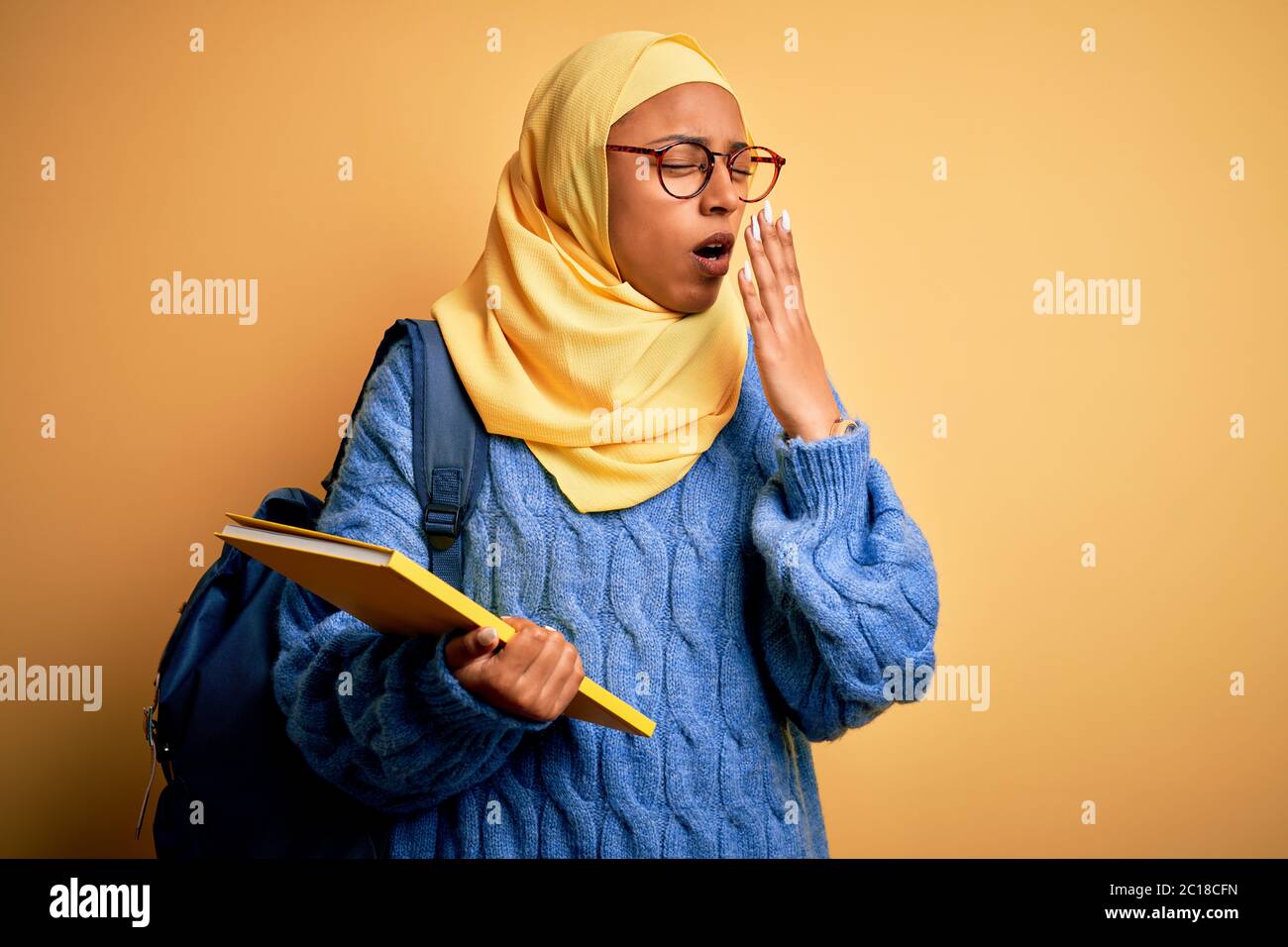 Young African American student woman wearing muslim hijab and backpack ...