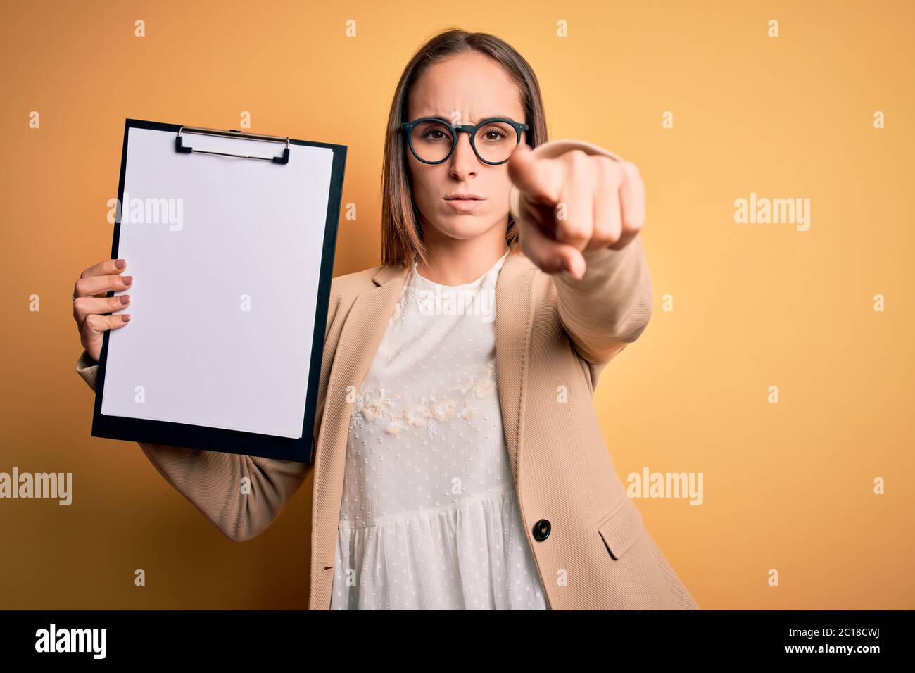 Beautiful inspector woman wearing glasses holding checklist clipboard ...