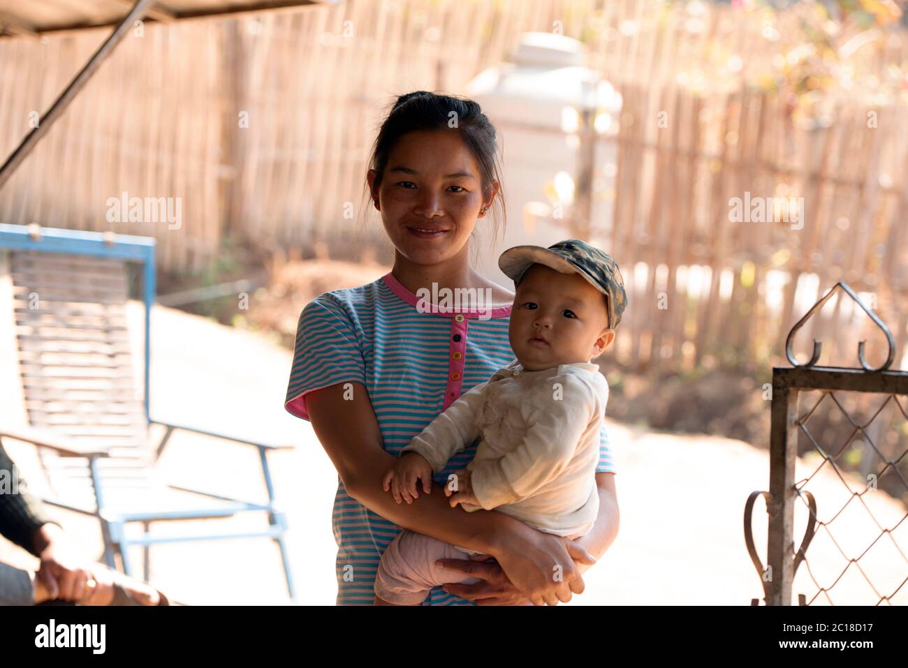 An indigenous, ethnic Shan woman and her baby in Kong Mung Mong village ...