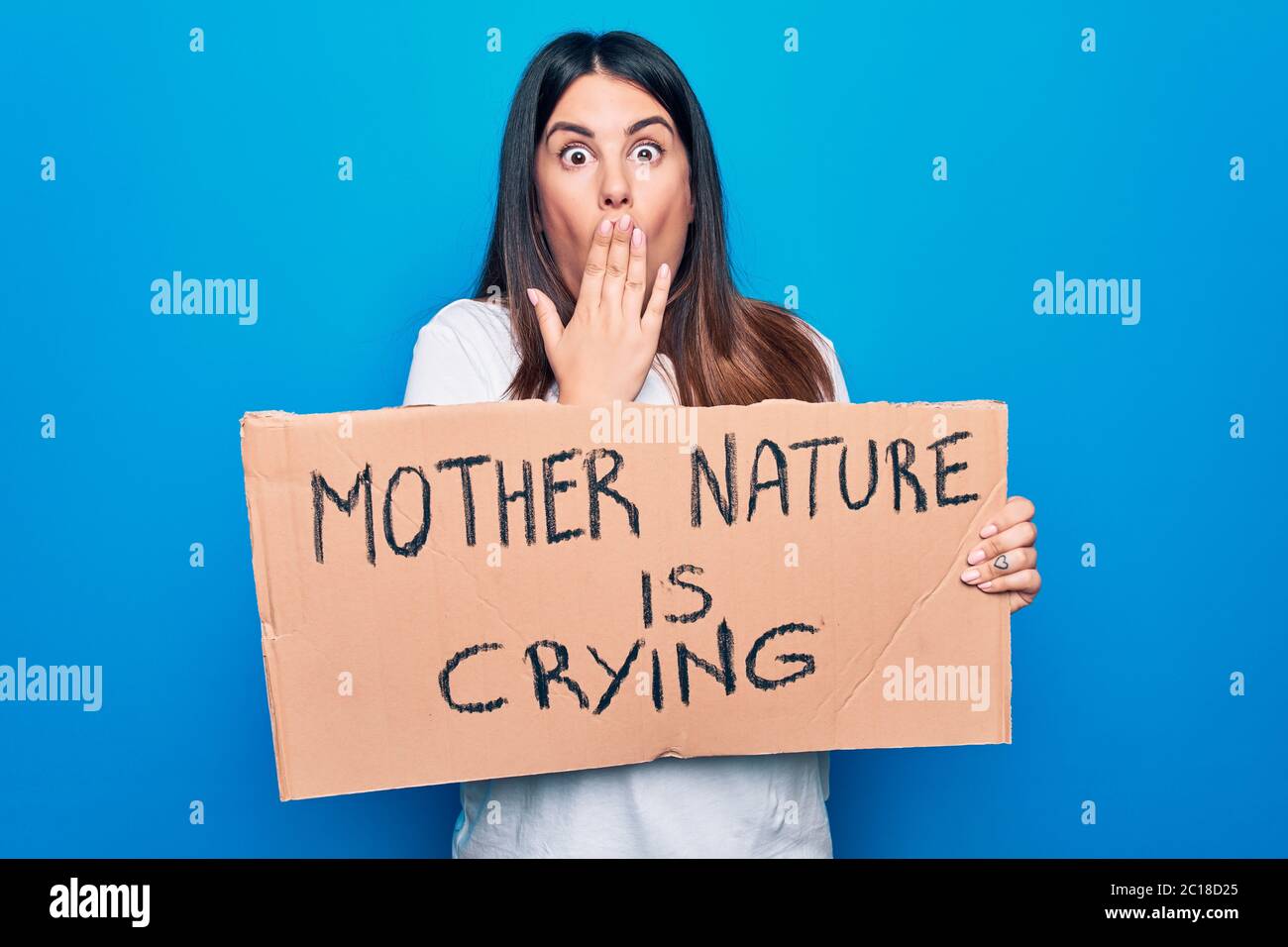 Young woman asking for environment care holding banner with mother ...